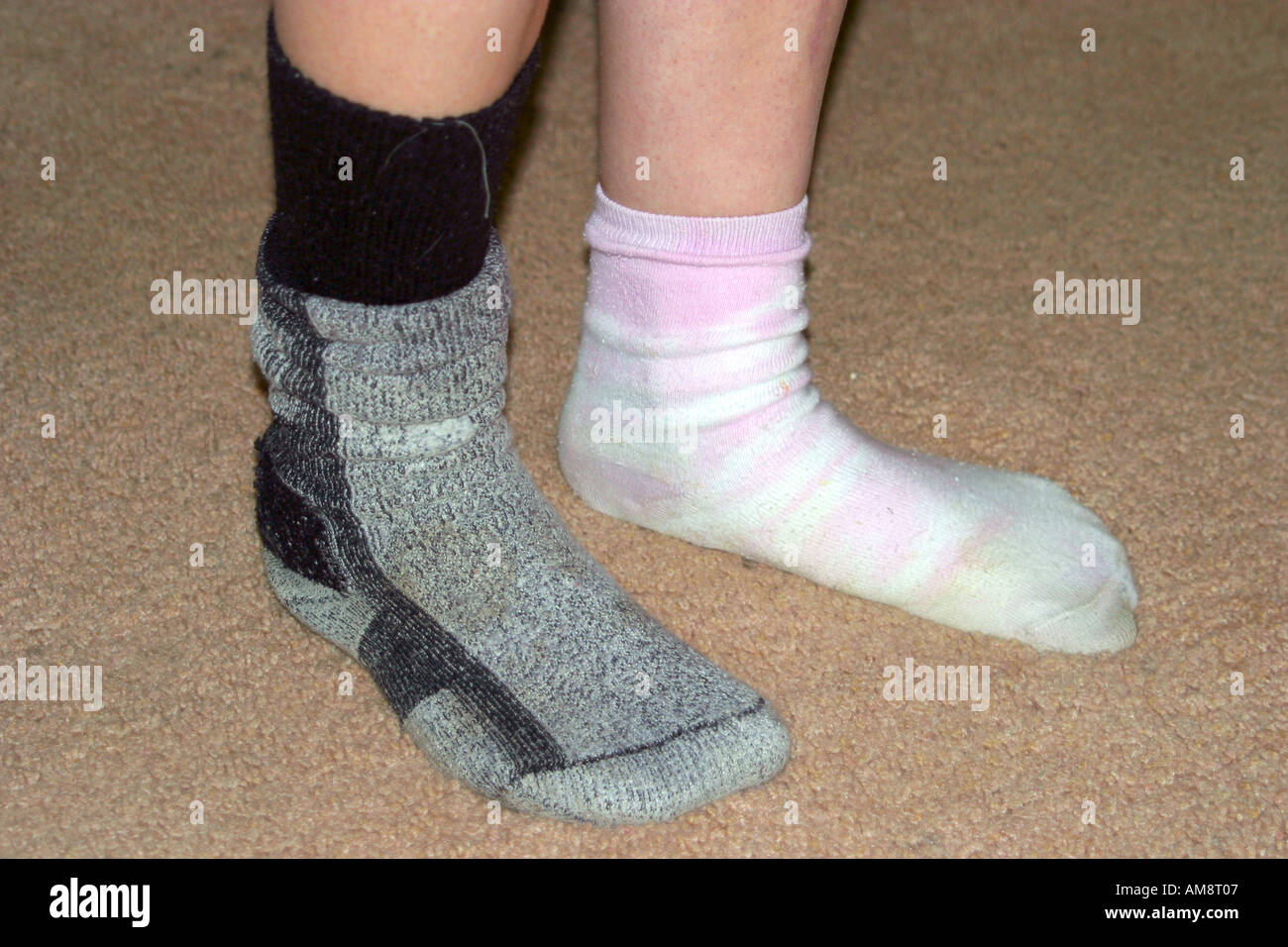 Teenagers feet with odd socks Stock Photo - Alamy