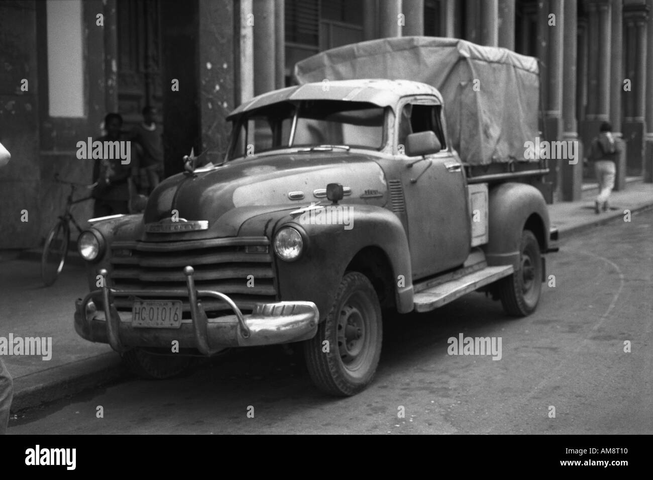 Old and rusty Chevrolet in a street in old Havanna near the Cathedral ...
