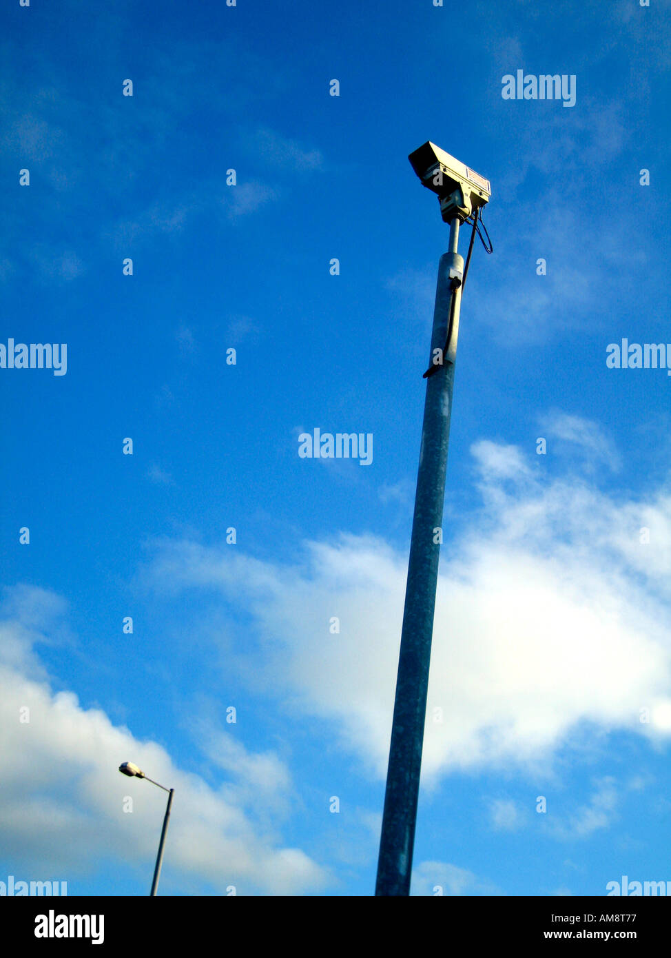 Security CCTV camera on high pole against blue sky Stock Photo - Alamy