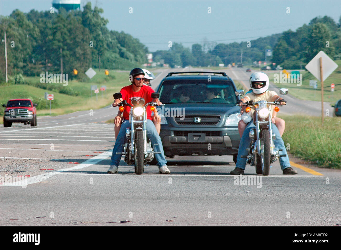 Cycles with headlights on for safety sitting in left turn lane of ...
