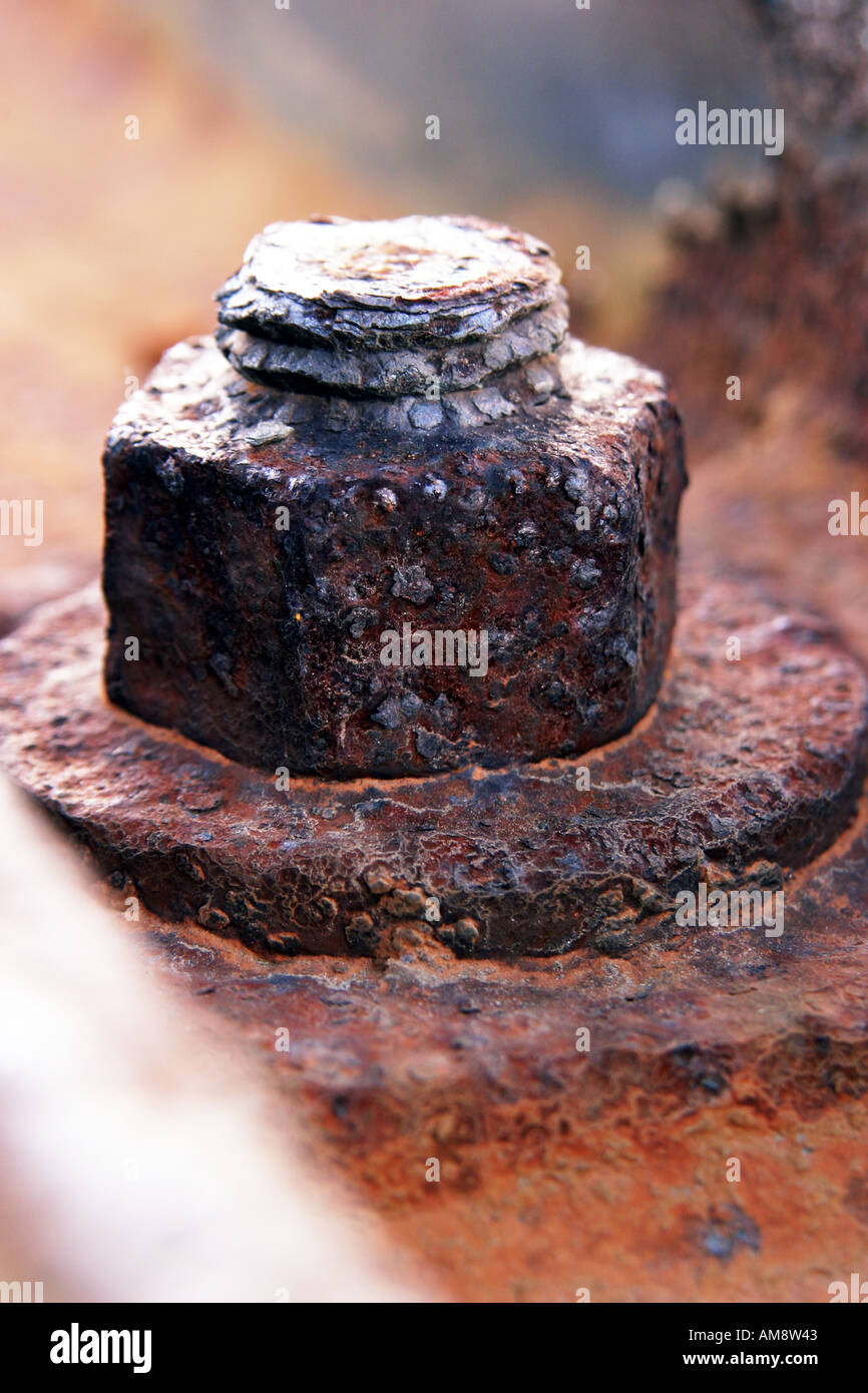 Abstract image of a rusting metal nut and bold on a old metal structure ...