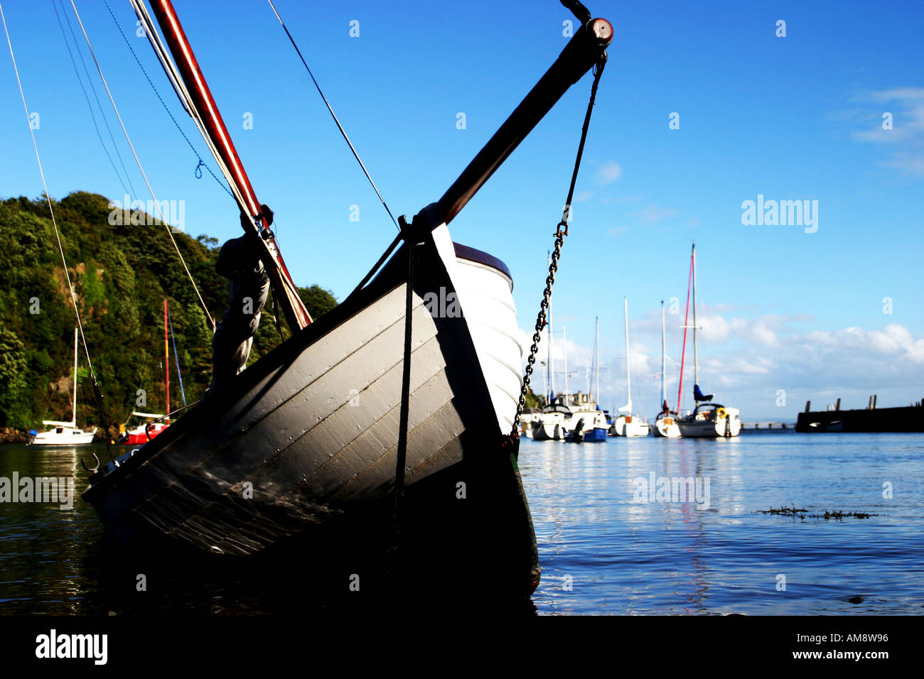 A small sailing boat resting on its side on the beach at aberdour ...