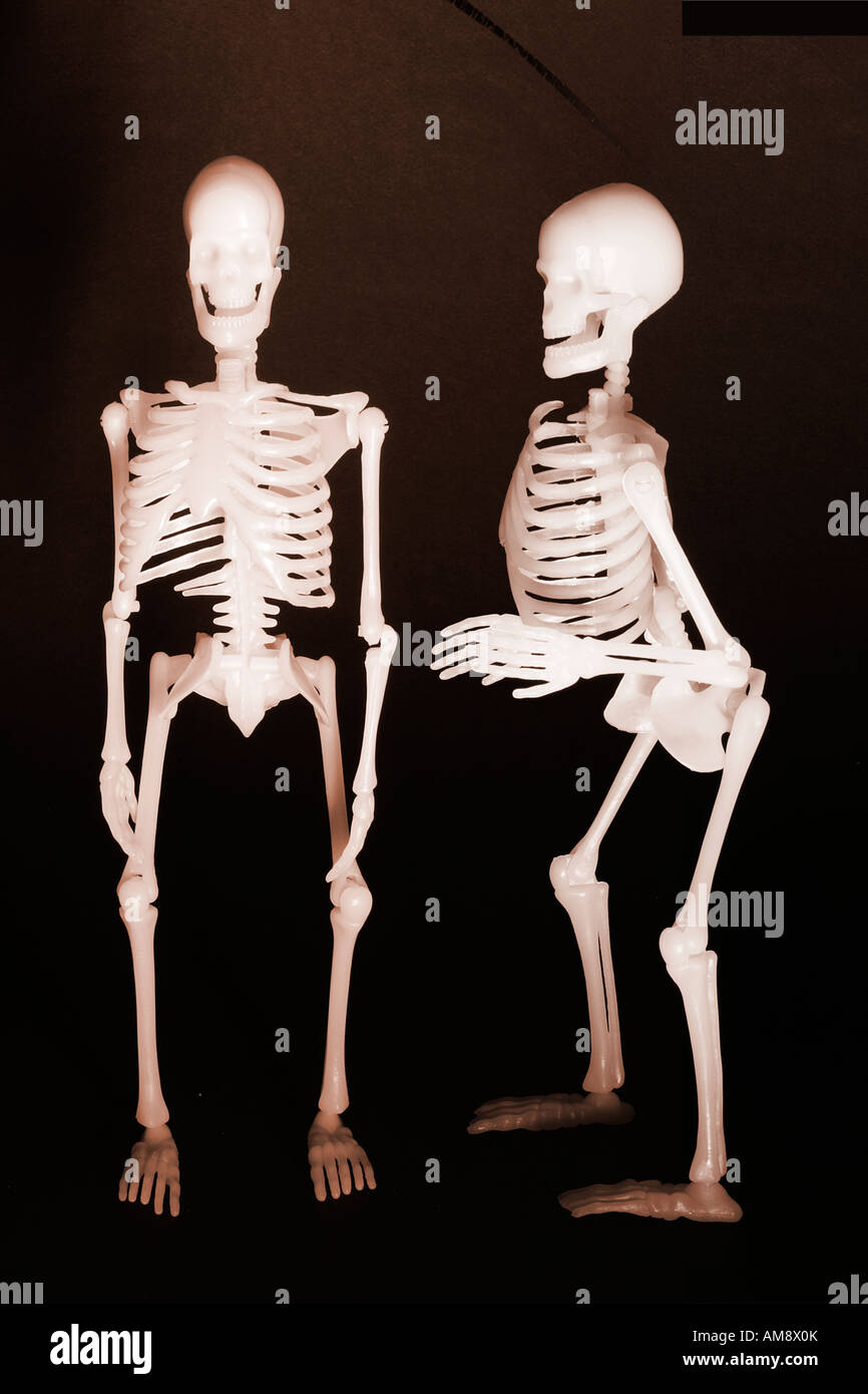 Skeletons Standing Against Black Background Stock Photo - Alamy