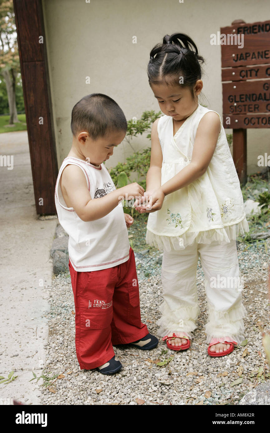 Children Looking at Objects in Hand Stock Photo - Alamy