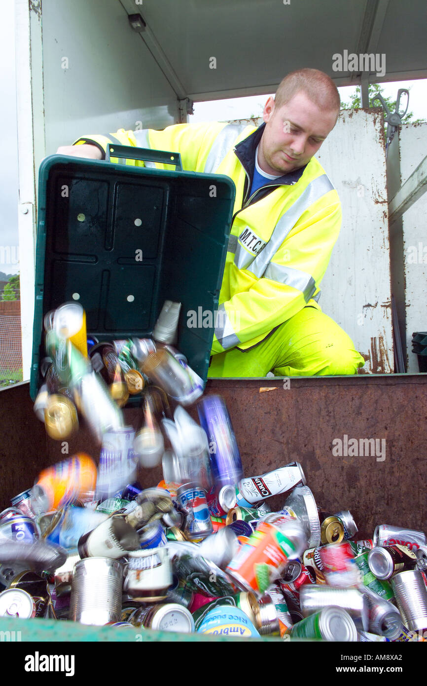 Man tipping cans into recycling large recycling bin Stock Photo - Alamy
