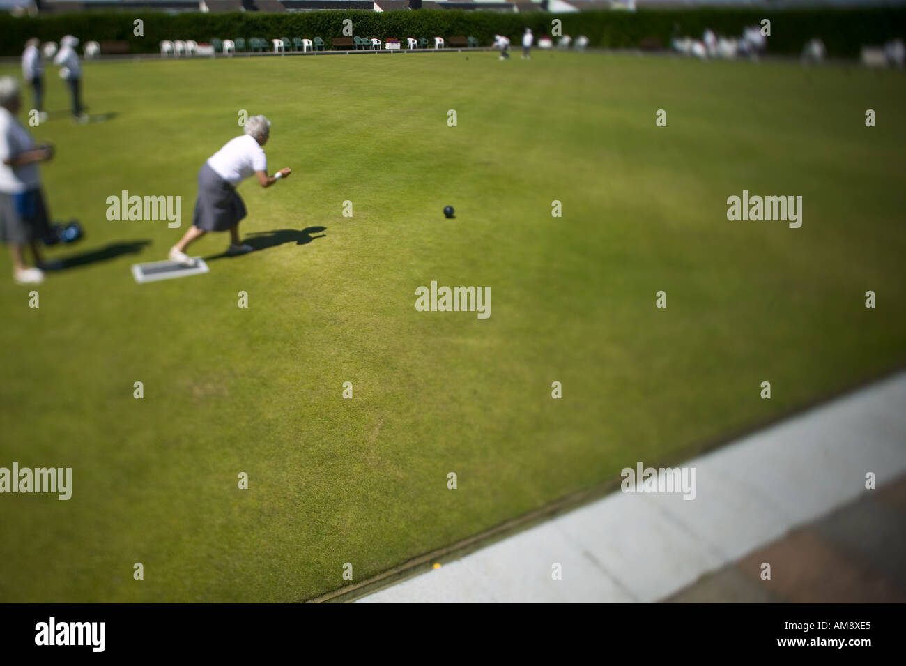 Retired persons playing lawn green bowls Stock Photo - Alamy