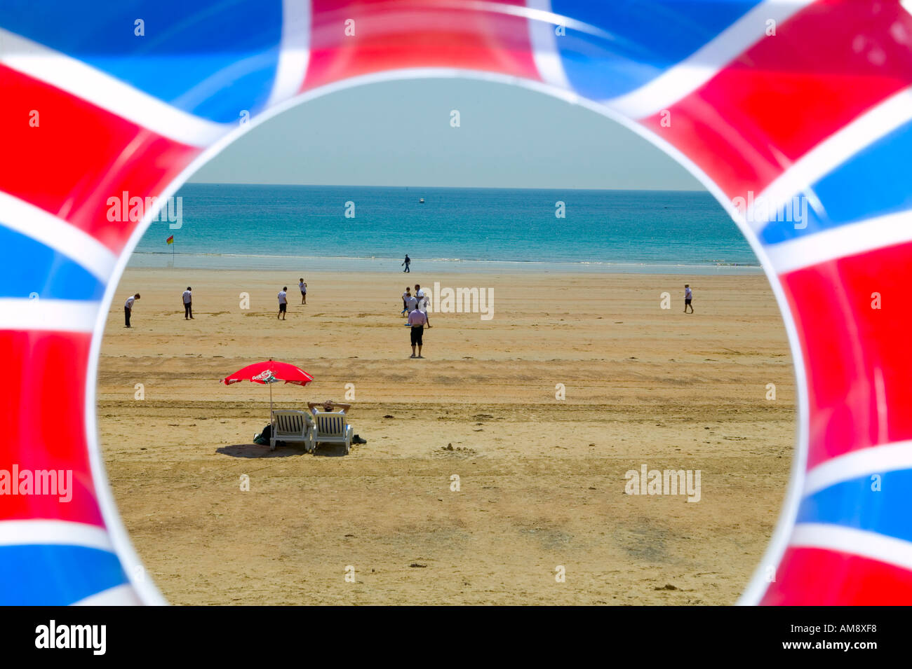 St Brelade s beach looking though a Union Jack inflatable jersey Stock ...