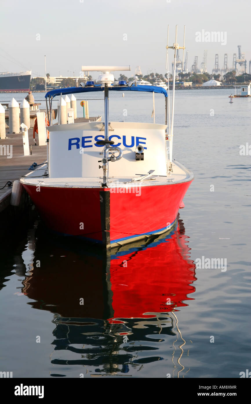 A red rescue boat with reflection in water Stock Photo - Alamy