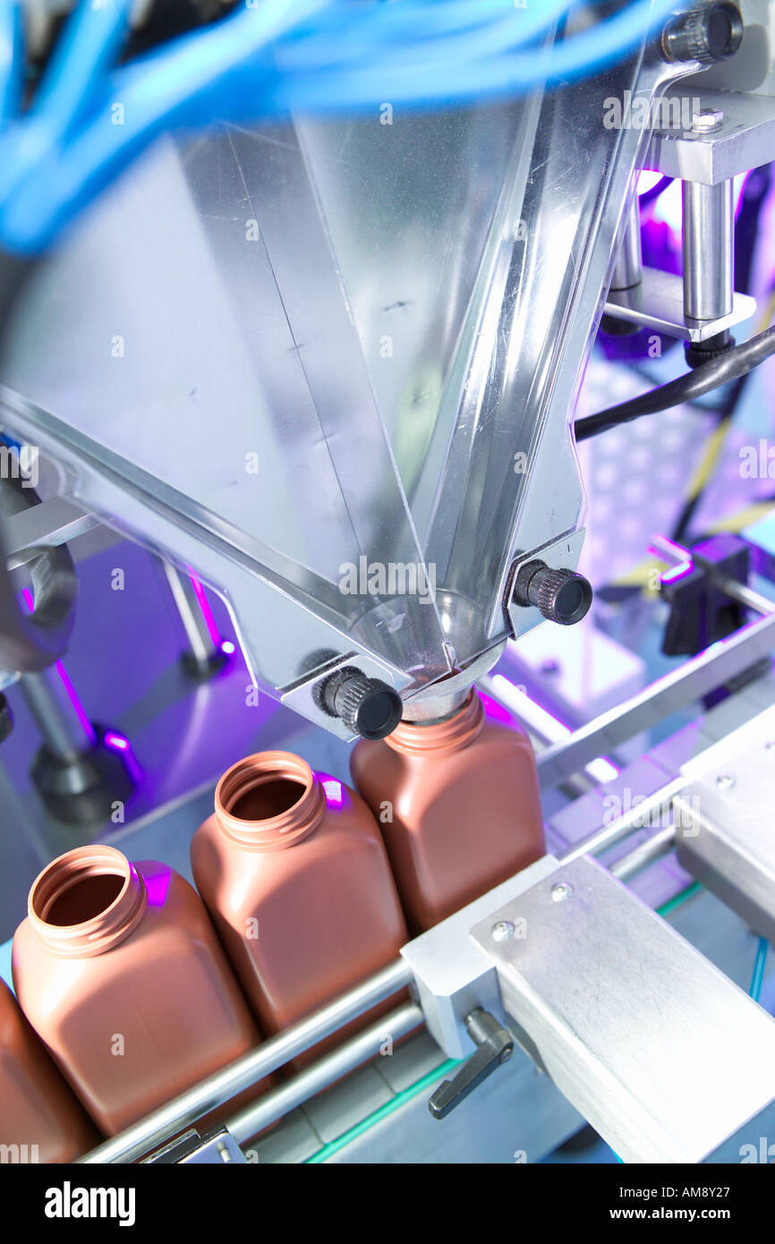 Pill bottles being filled on production line at pharmaceutical factory ...