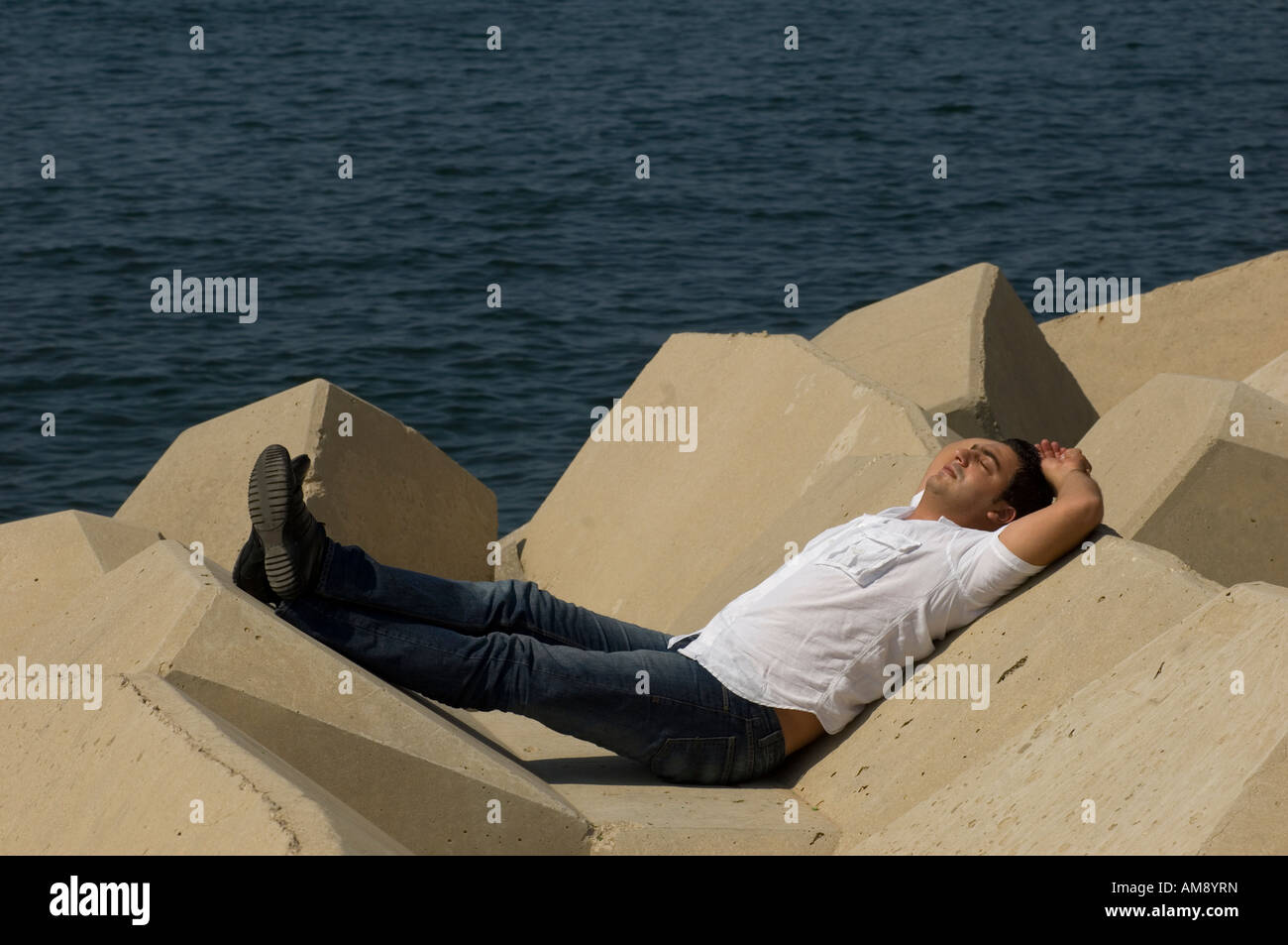 Adult laying on rocks hi-res stock photography and images - Alamy