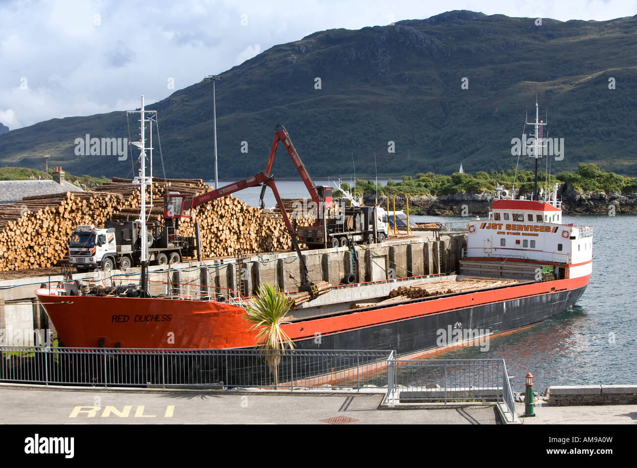 Timber Cargo Ship Being Loaded, Kyle of Lochalsh, Scotland, UK Stock ...