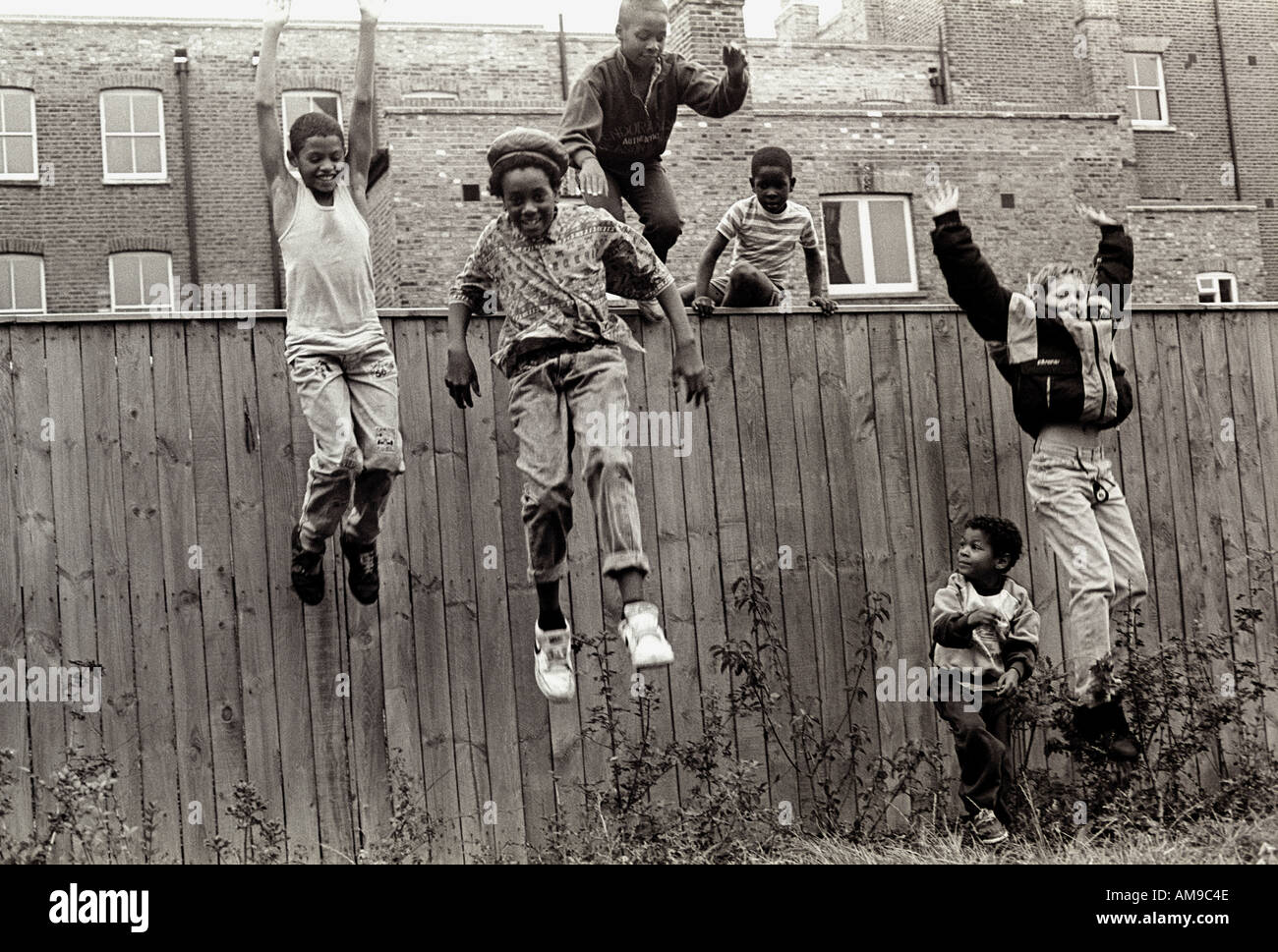 Person climbing over wall fence hi-res stock photography and images - Alamy