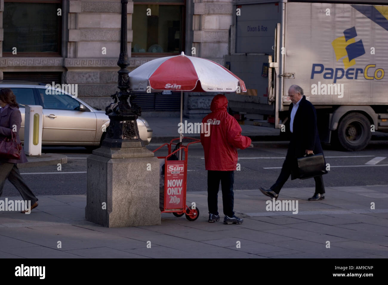 Newsprint. Street vendor selling the sun newspaper, with paper van in ...