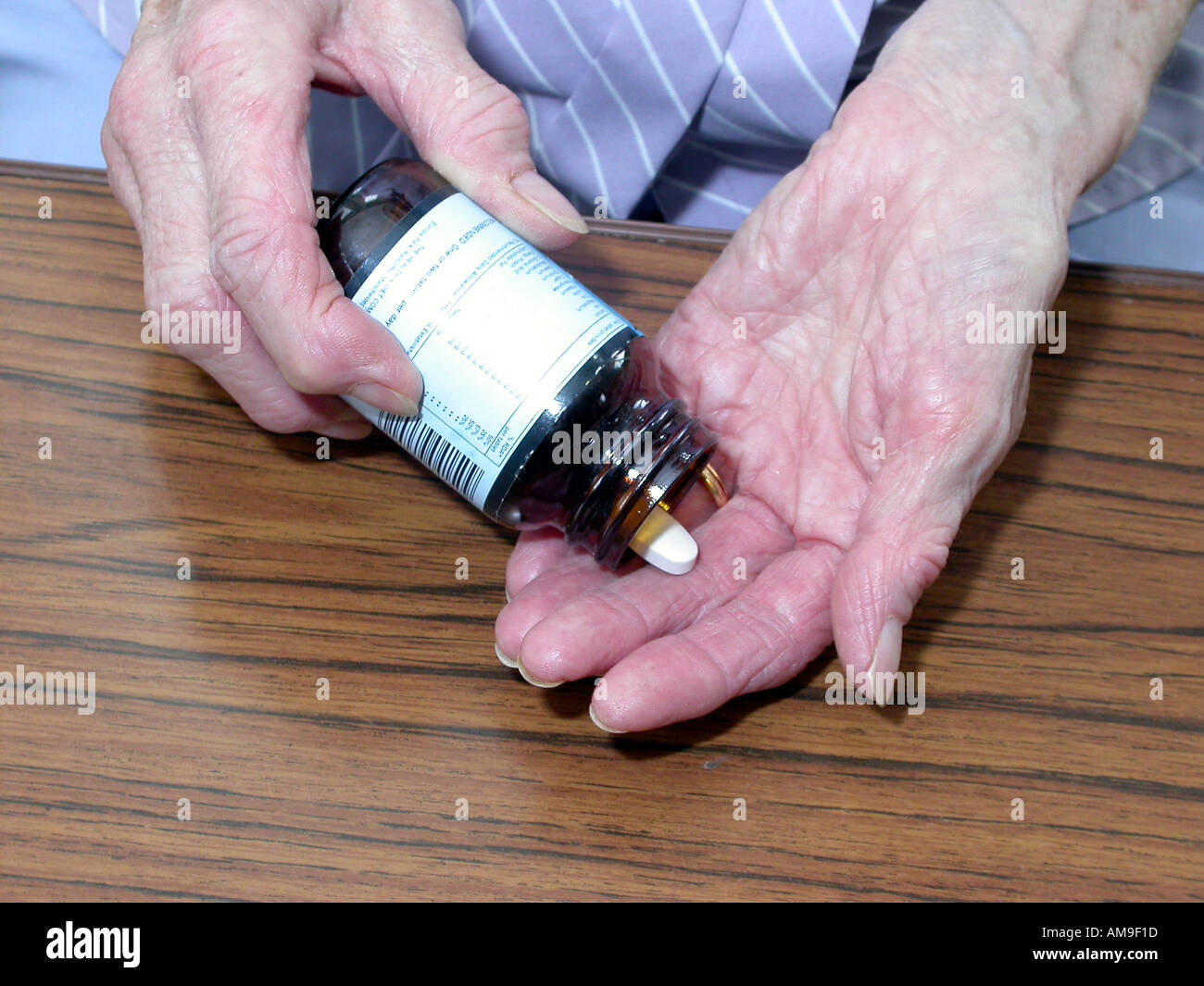 elderly lady taking tablets Stock Photo - Alamy