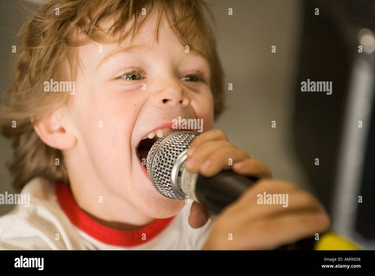 three year old child singing with microphone Stock Photo - Alamy