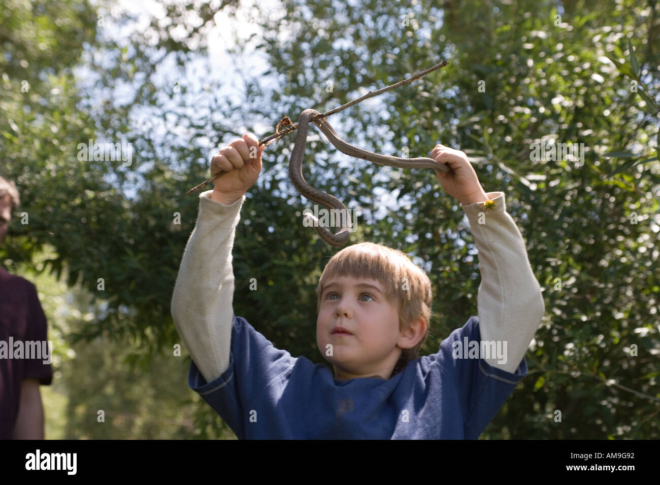 Boy with snake hi-res stock photography and images - Alamy