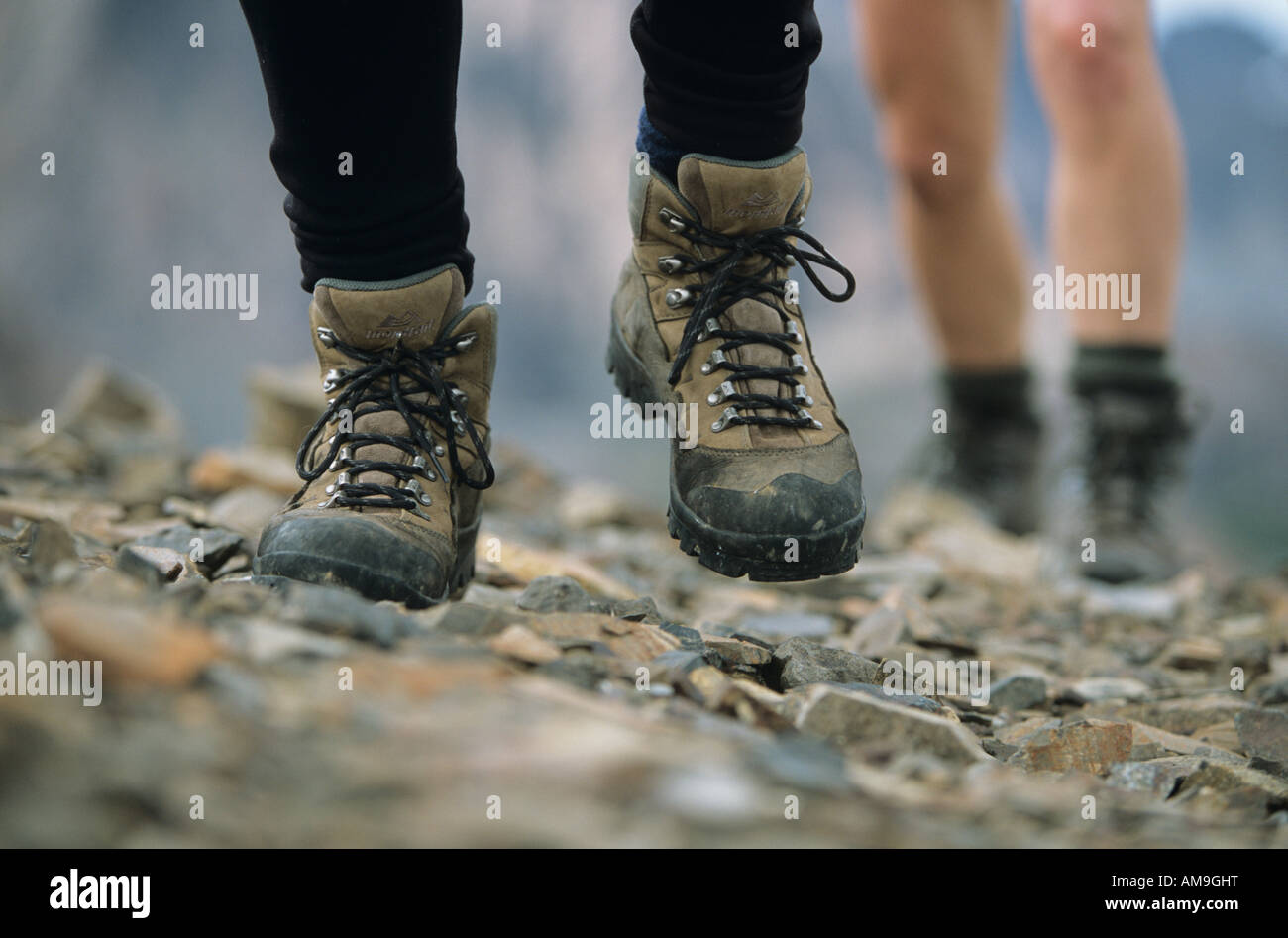 Hikers feet and legs on rocky trail Stock Photo - Alamy