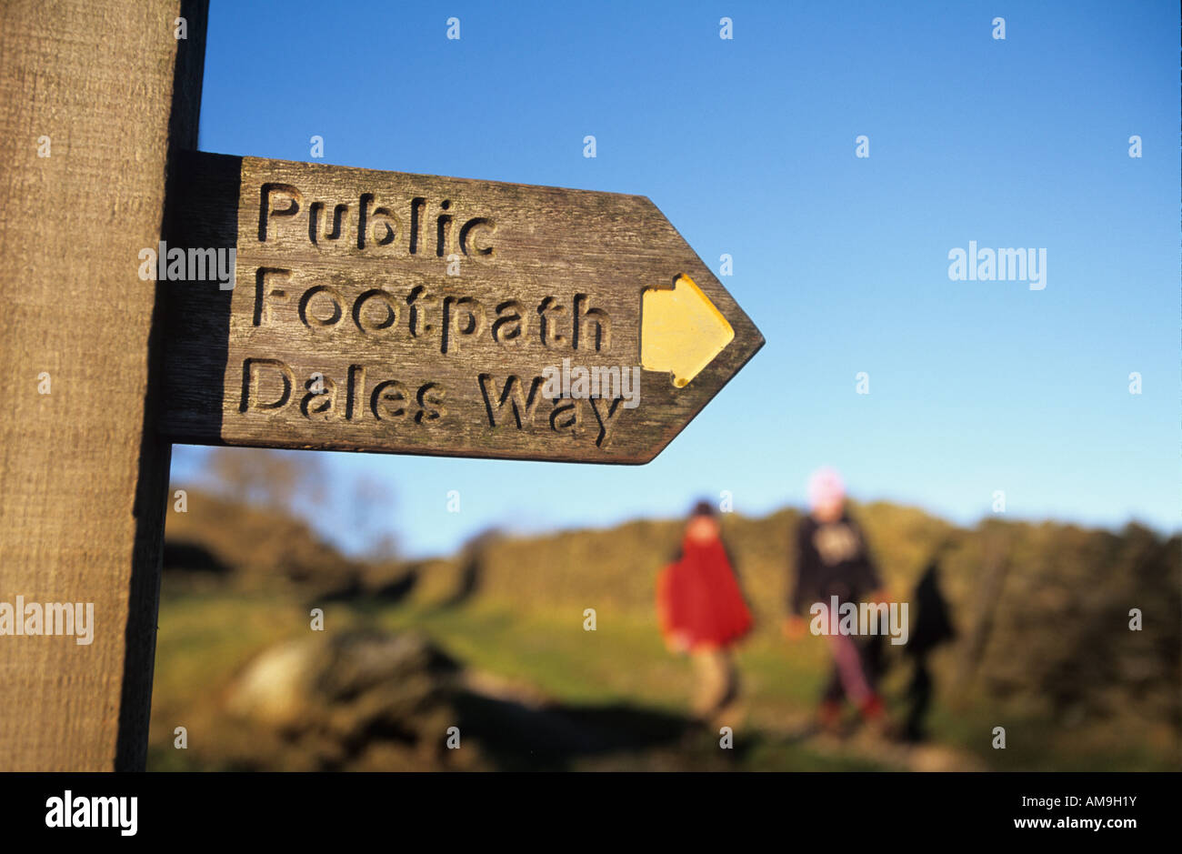 Hikers with Dales Way footpath sign in foreground Stock Photo - Alamy
