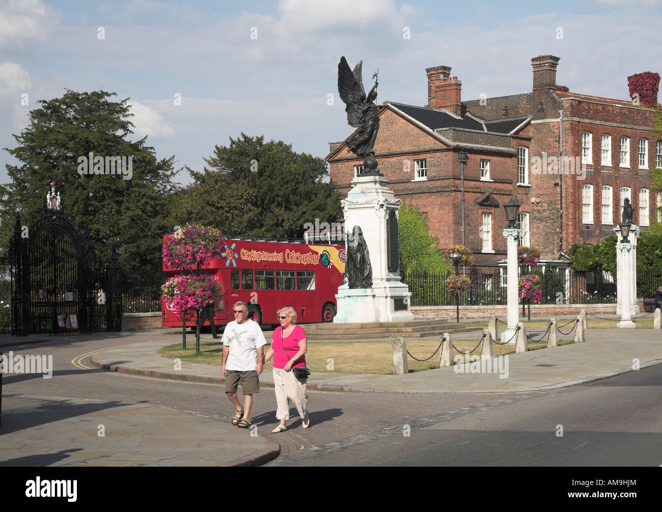 Red open topped double decker bus, statue, couple walking, Hallowtrees ...