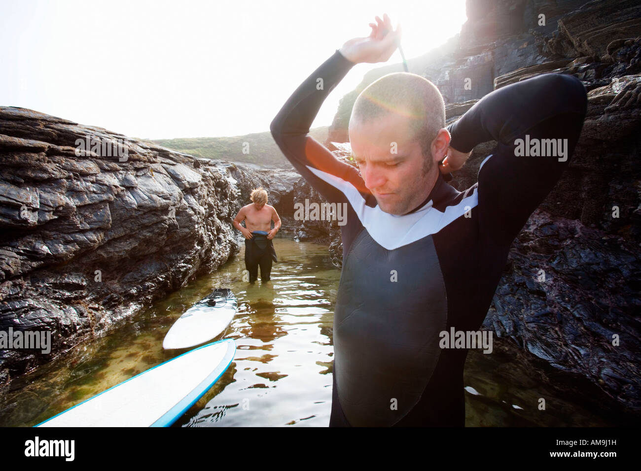 Two men in the water getting ready to surf Stock Photo - Alamy
