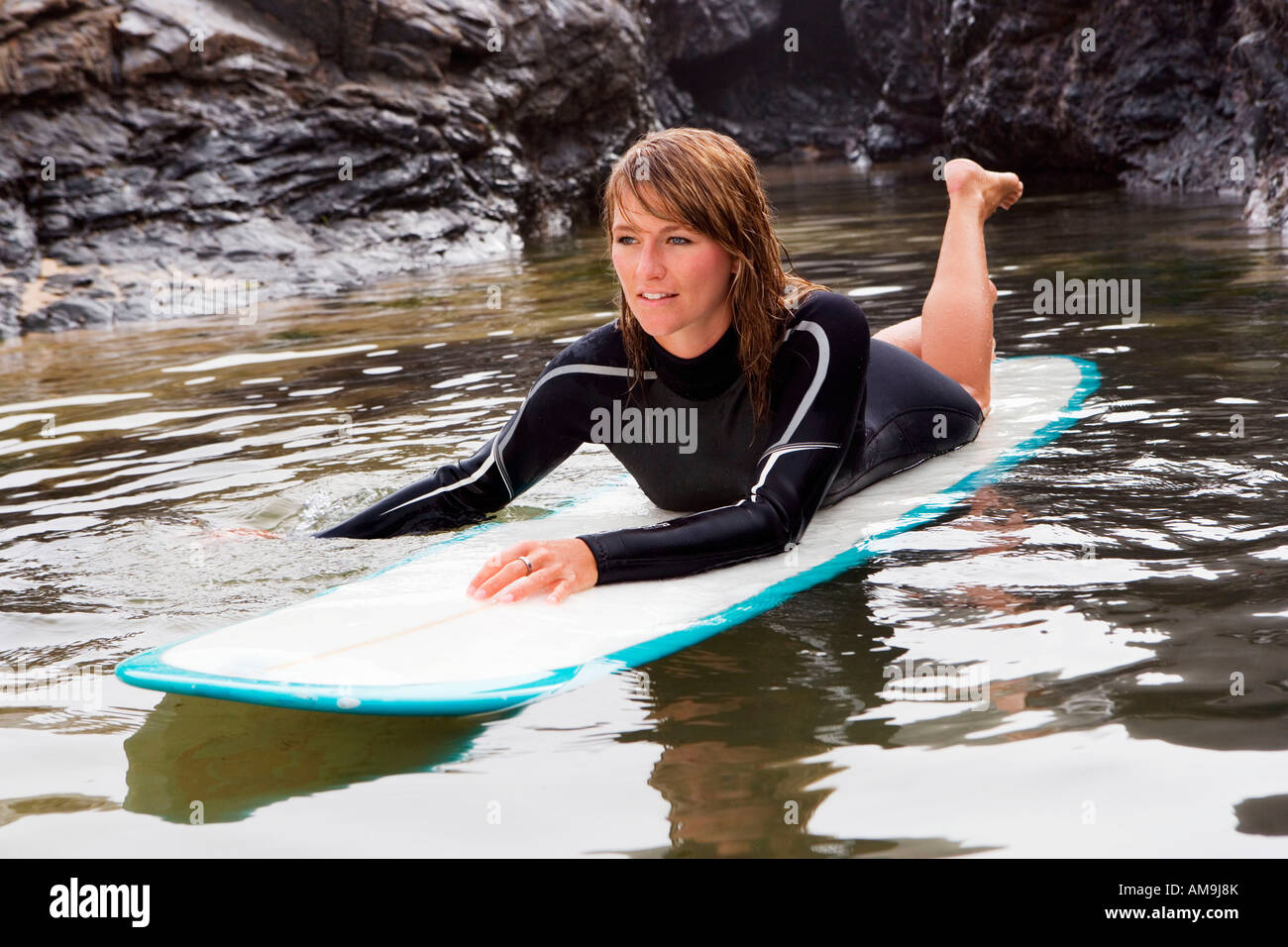 Woman surfer lying on surf board hi-res stock photography and images ...