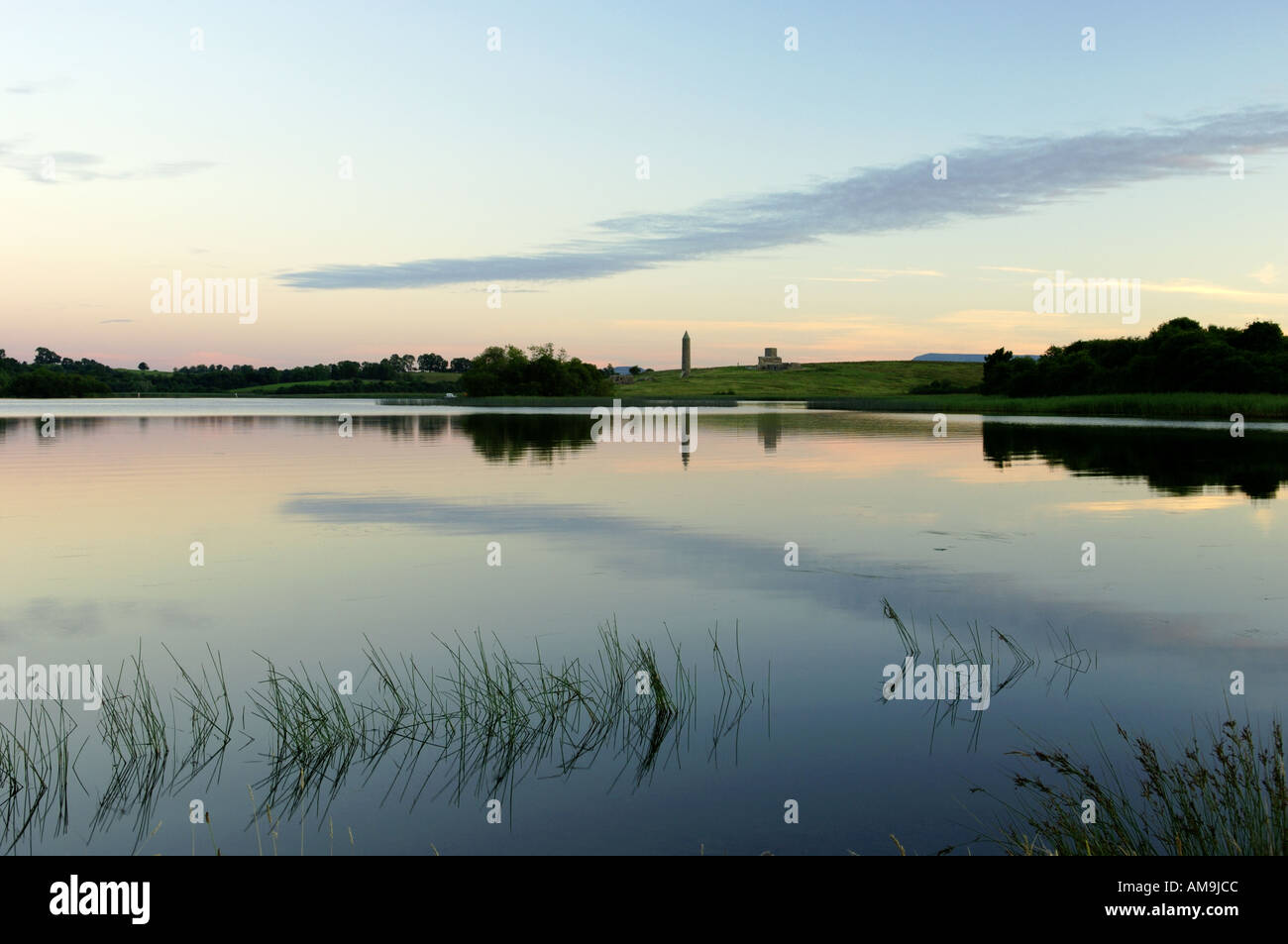 Devenish Island round tower and monastic ruins seen from east shore of ...