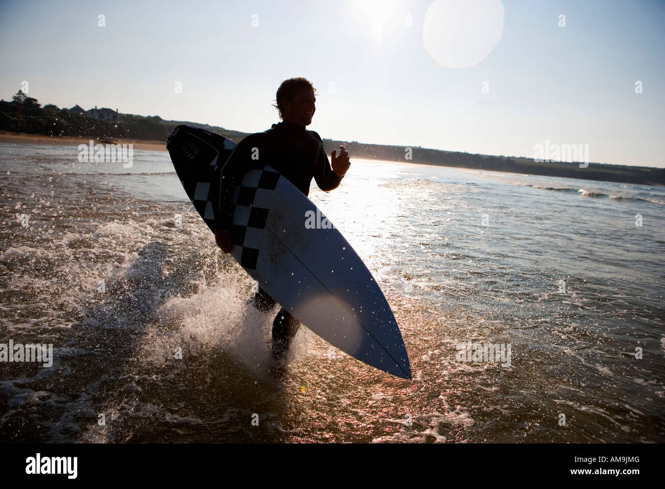 Man running through water surfboard hi-res stock photography and images ...