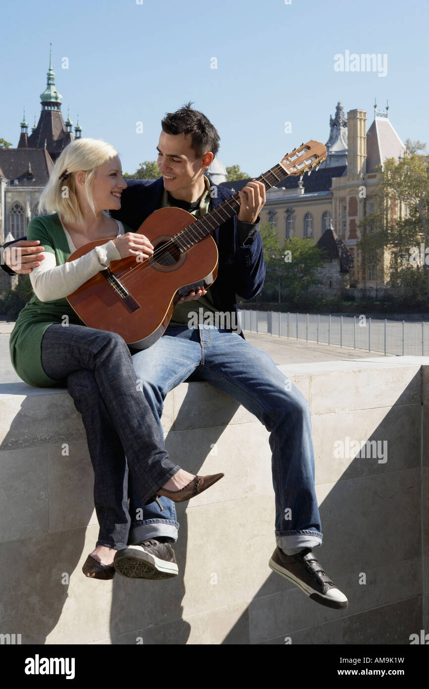 Young couple playing guitar guitars hi-res stock photography and images ...