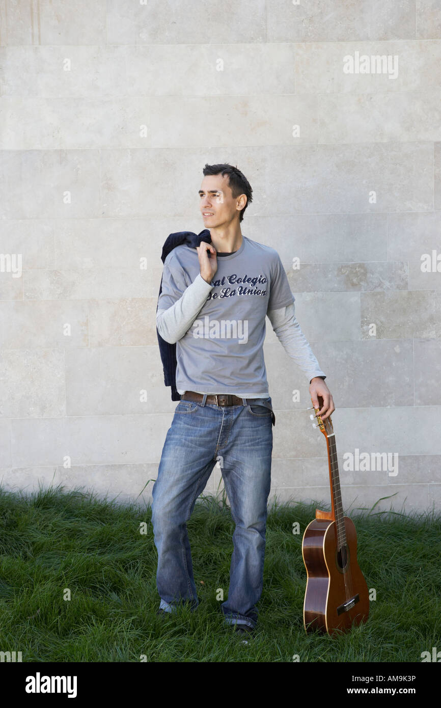 Man standing with a guitar Stock Photo - Alamy