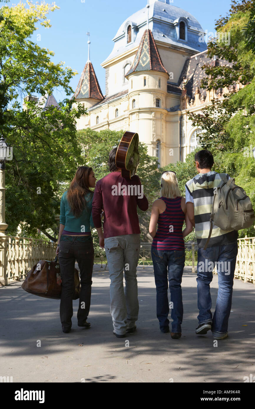 Four friends walking on a bridge Stock Photo - Alamy