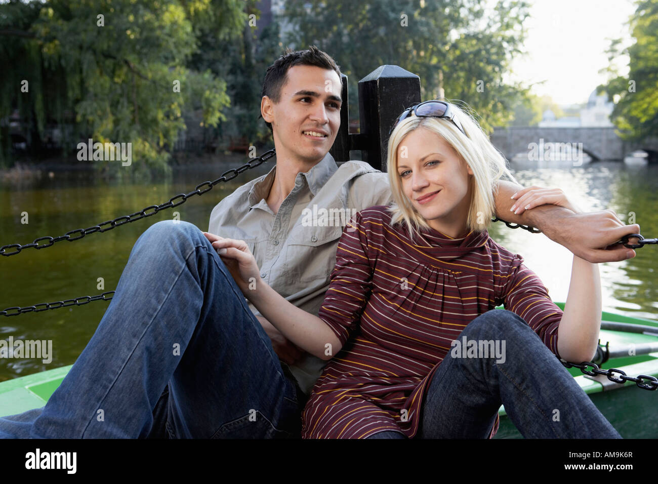 Couple on a dock smiling and relaxing Stock Photo - Alamy