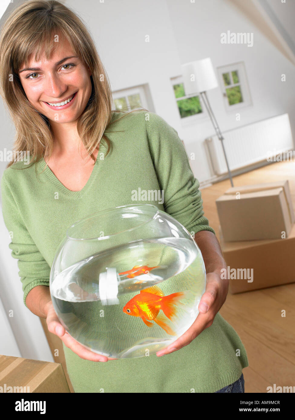 Woman looking goldfish hi-res stock photography and images - Alamy