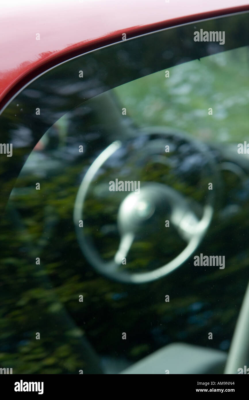 Car steering wheel seen through the glass window Stock Photo - Alamy
