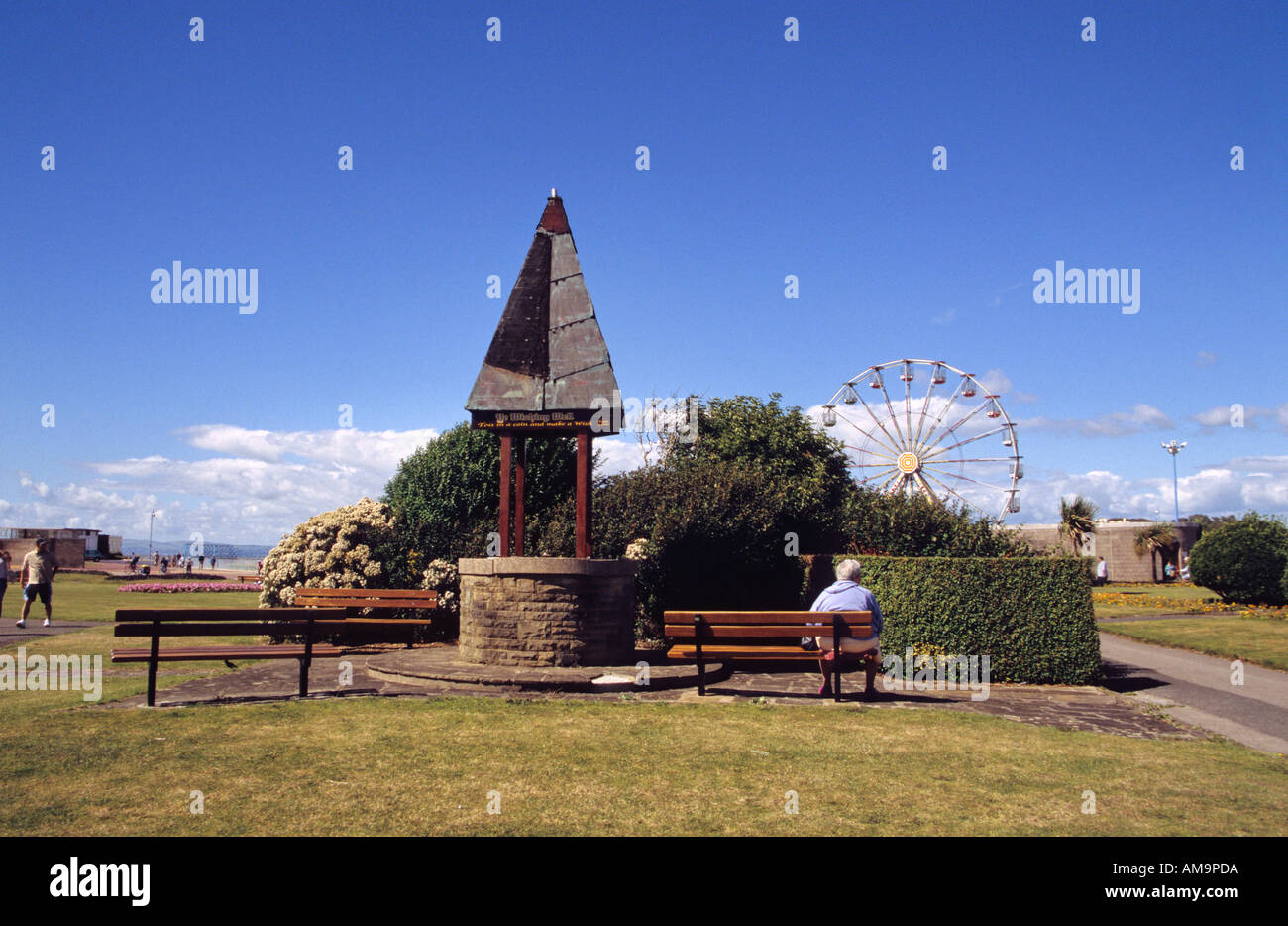 Wishing well and fair on the promenade at Morecambe Stock Photo - Alamy