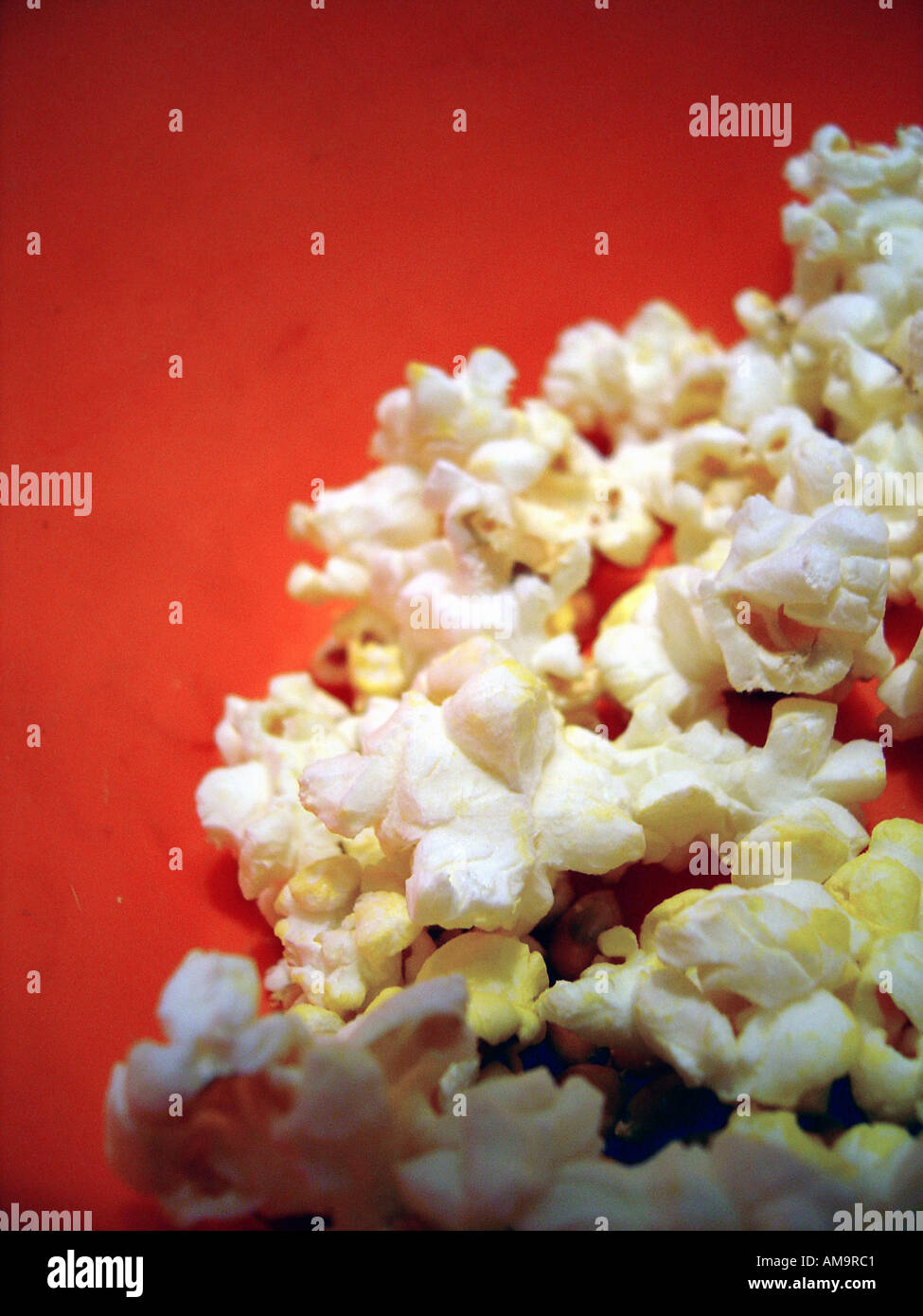 Still Life of Popcorn Against an Orange Colored Background Copy Space ...