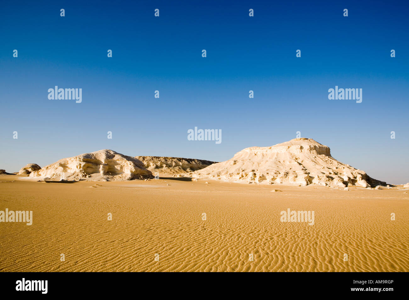 Rippled sand and white limestone outcrop , White Desert , near Farafra ...