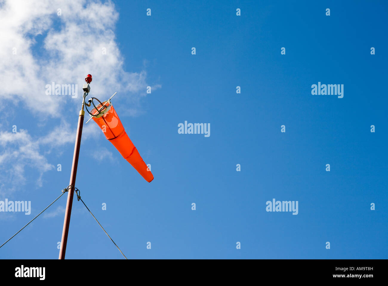 Red windsock against blue sky and clouds, Island of Tobago Caribbean ...