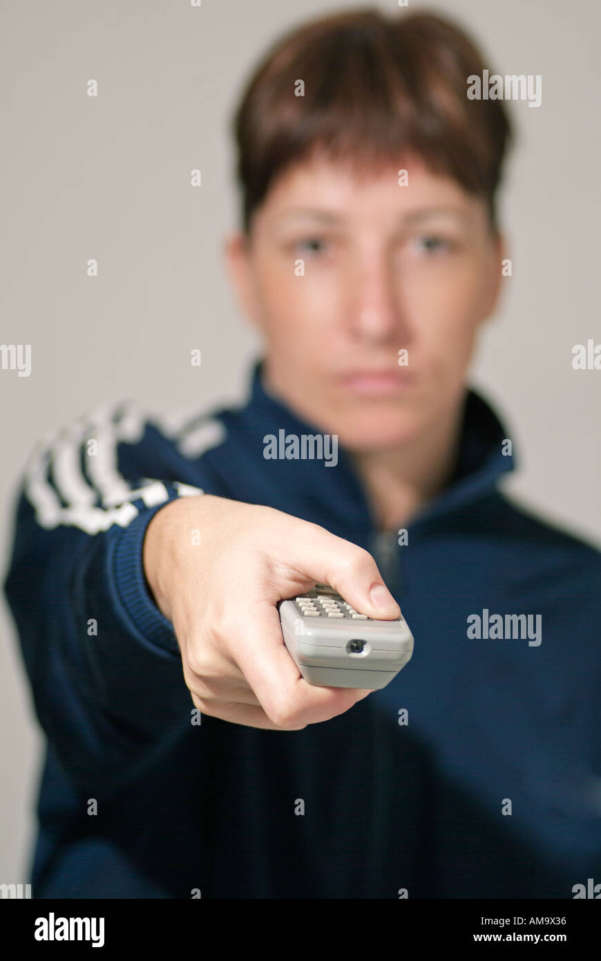 Young Woman Changing Channel with a Remote Control Handset Stock Photo ...