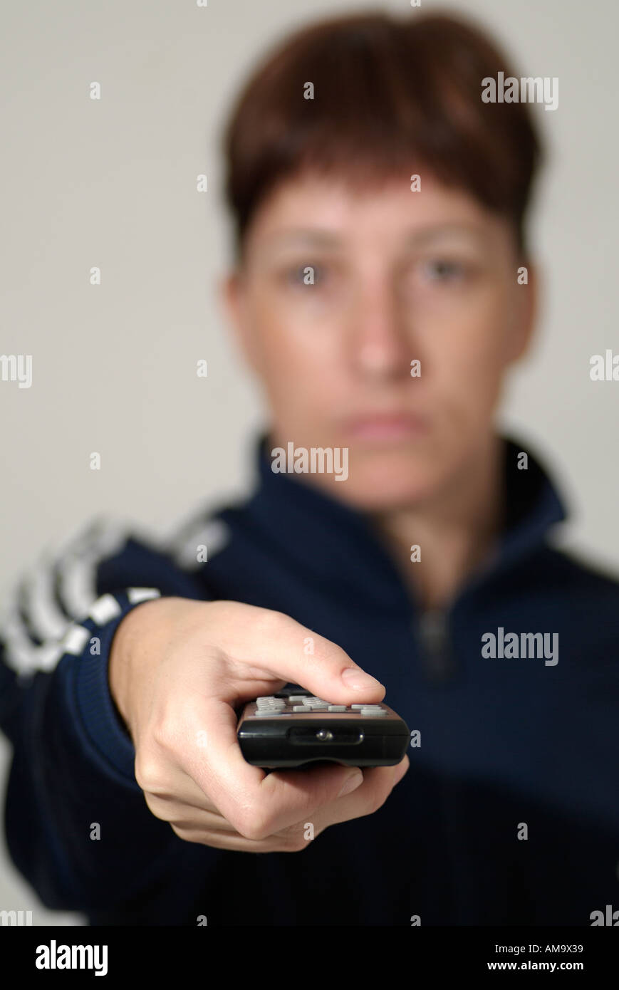 Young Woman Changing Channel with a Remote Control Handset Stock Photo ...