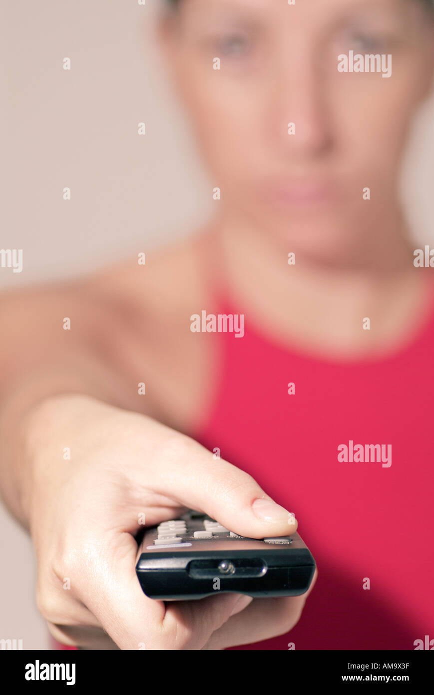Young Woman Using a Remote Control Stock Photo - Alamy Young Woman Using a Remote Control Stock Photo - Alamy