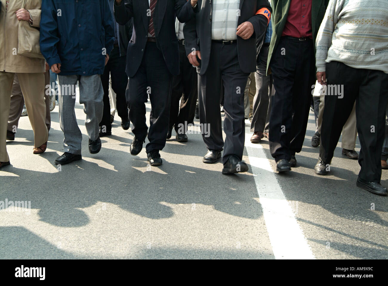 Demonstrators Marching Along a Street During a Protest. Low Angle Stock ...