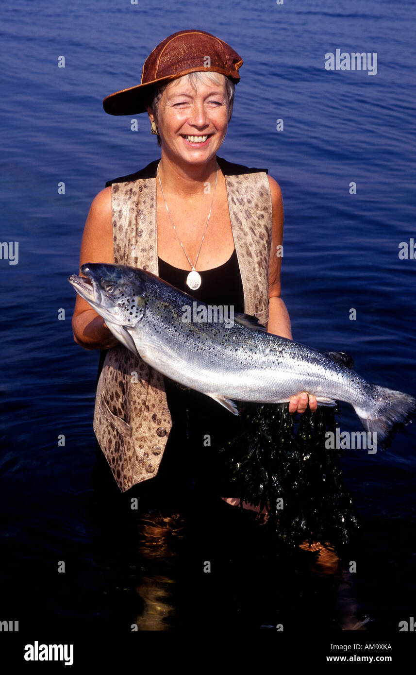 Woman fish salmon catch happy happiness fishing hi-res stock ...