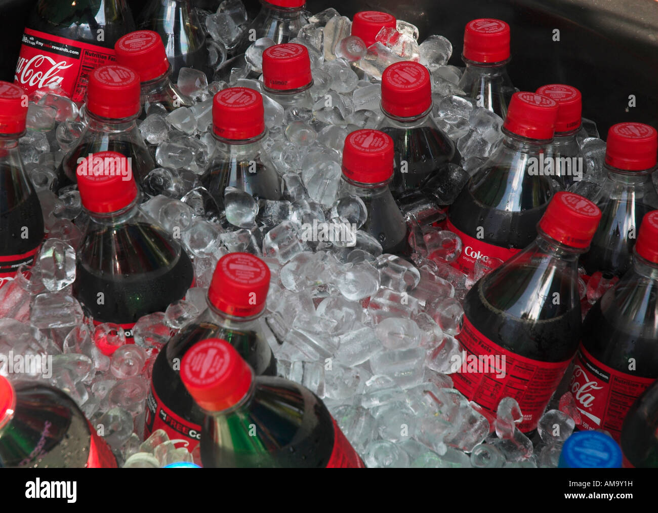 Bottles of fizzy drink in ice Stock Photo - Alamy