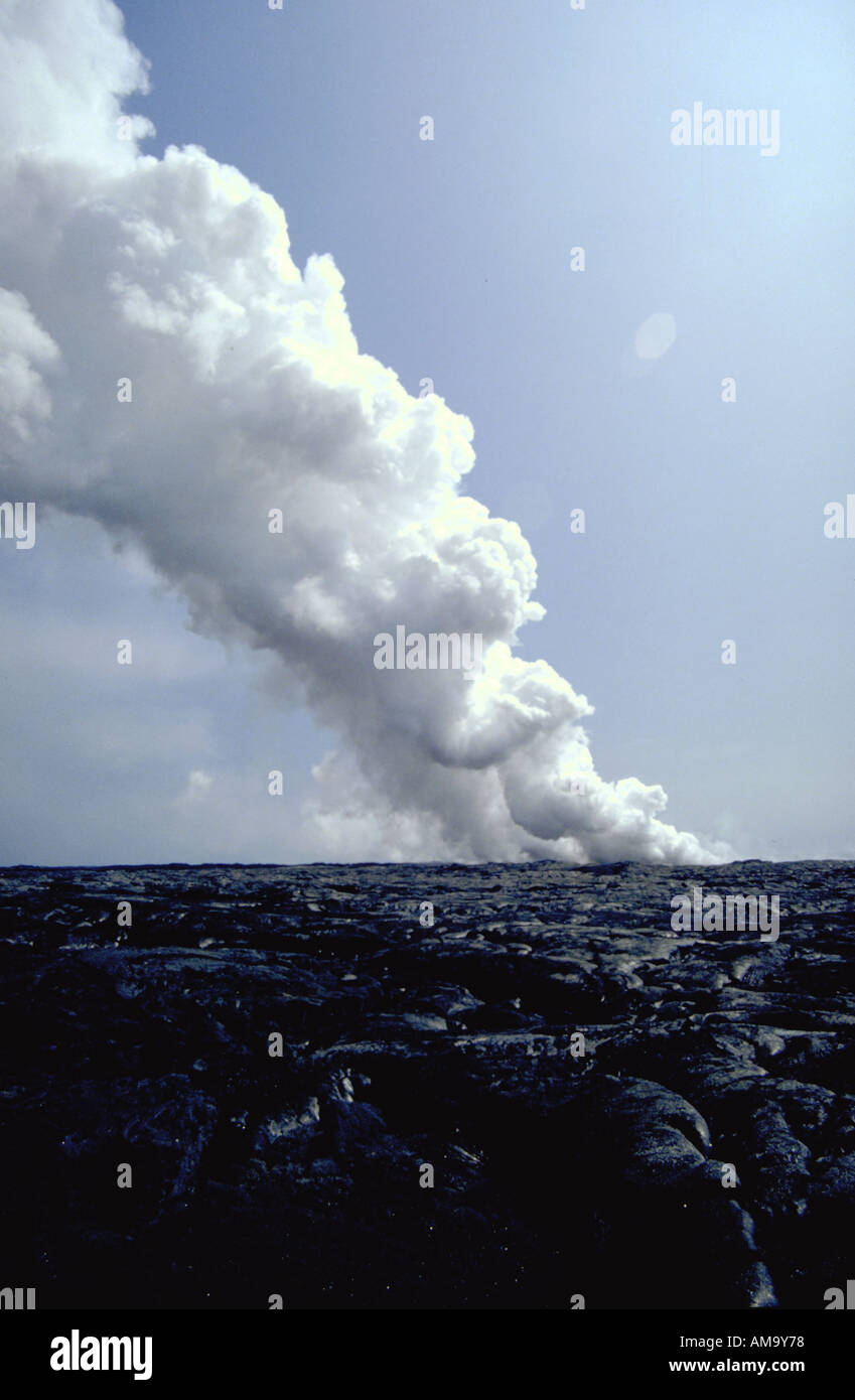 Kilauea volcano lava flow across the beach and road with a large plume ...