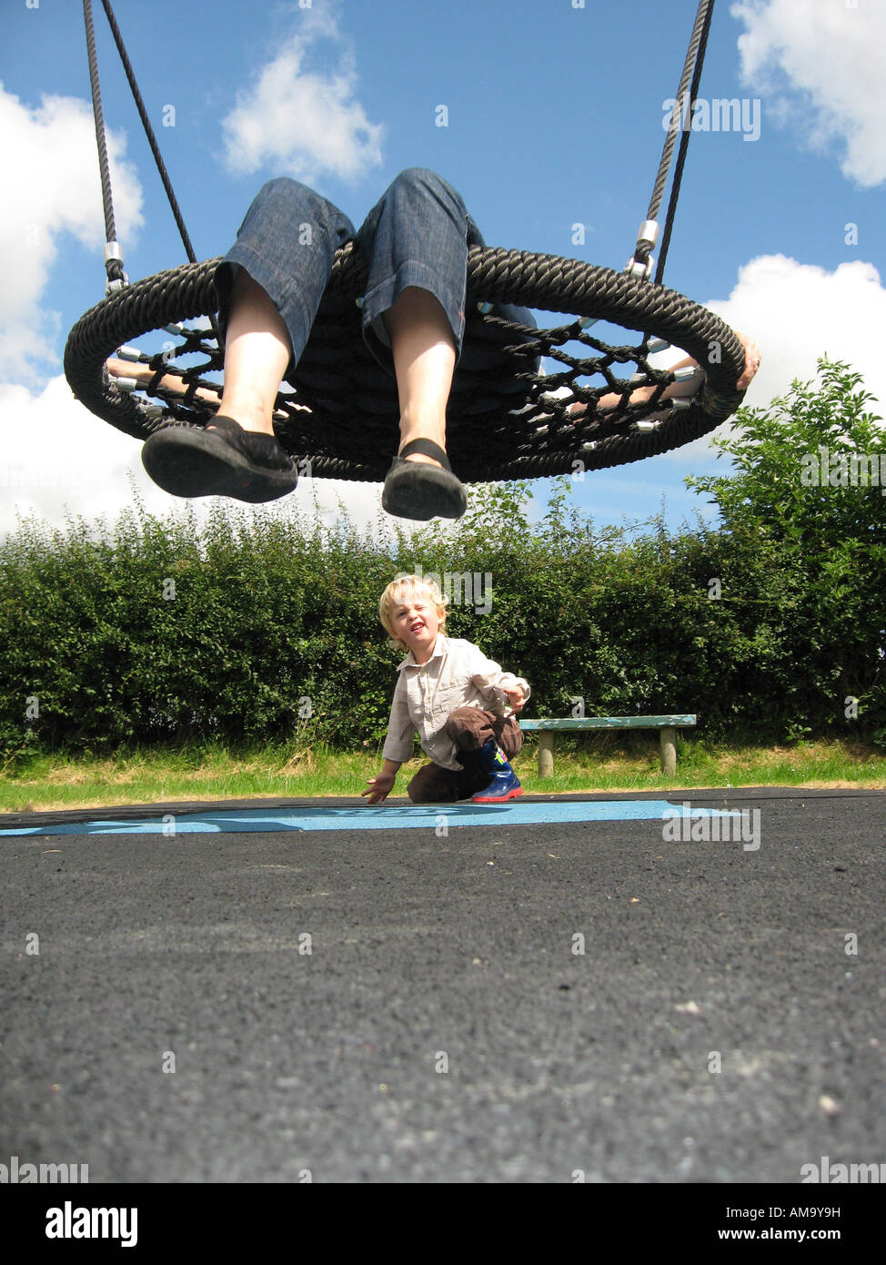 Mother son playground swing hi-res stock photography and images - Alamy