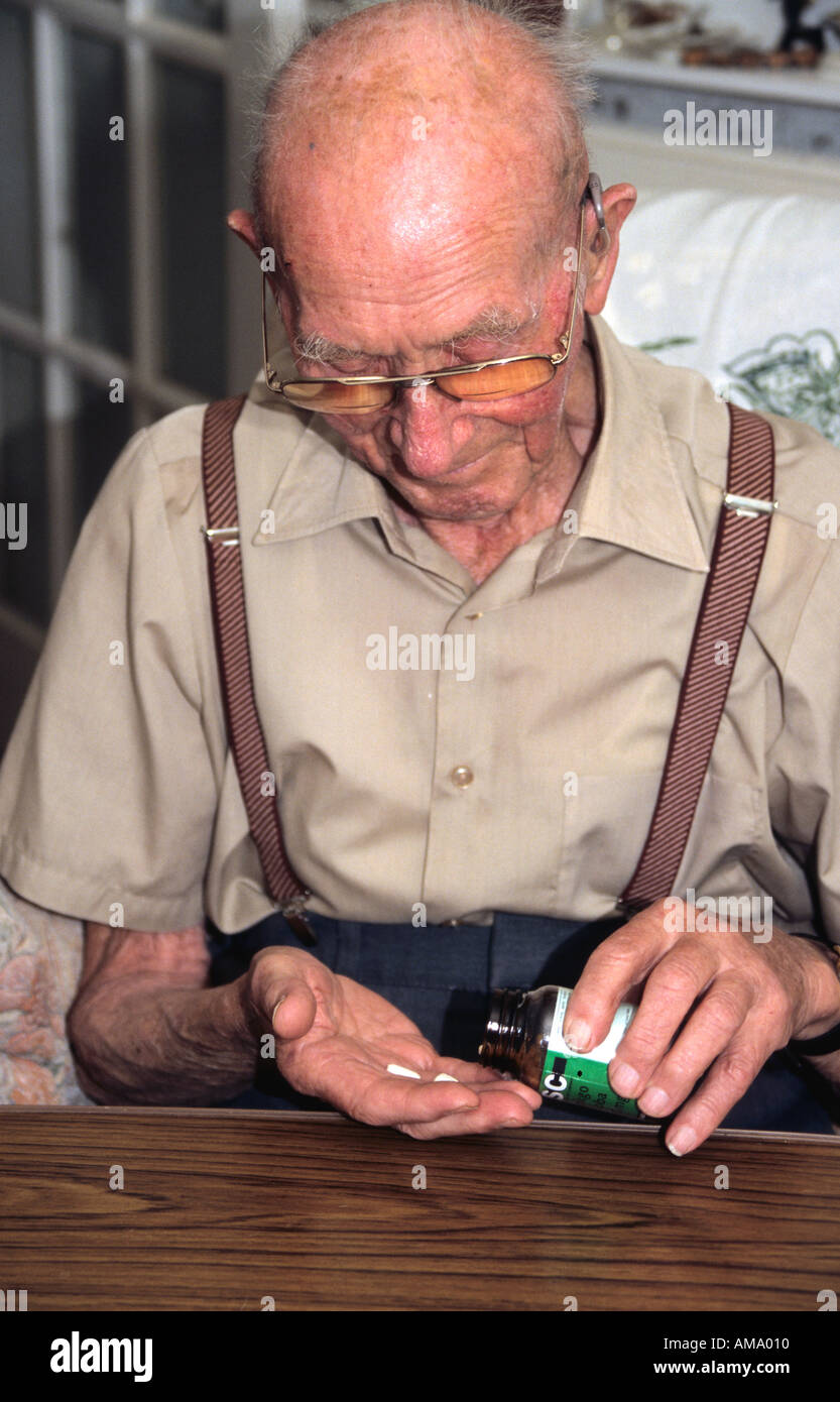 Pensioner taking tablets hi-res stock photography and images - Alamy