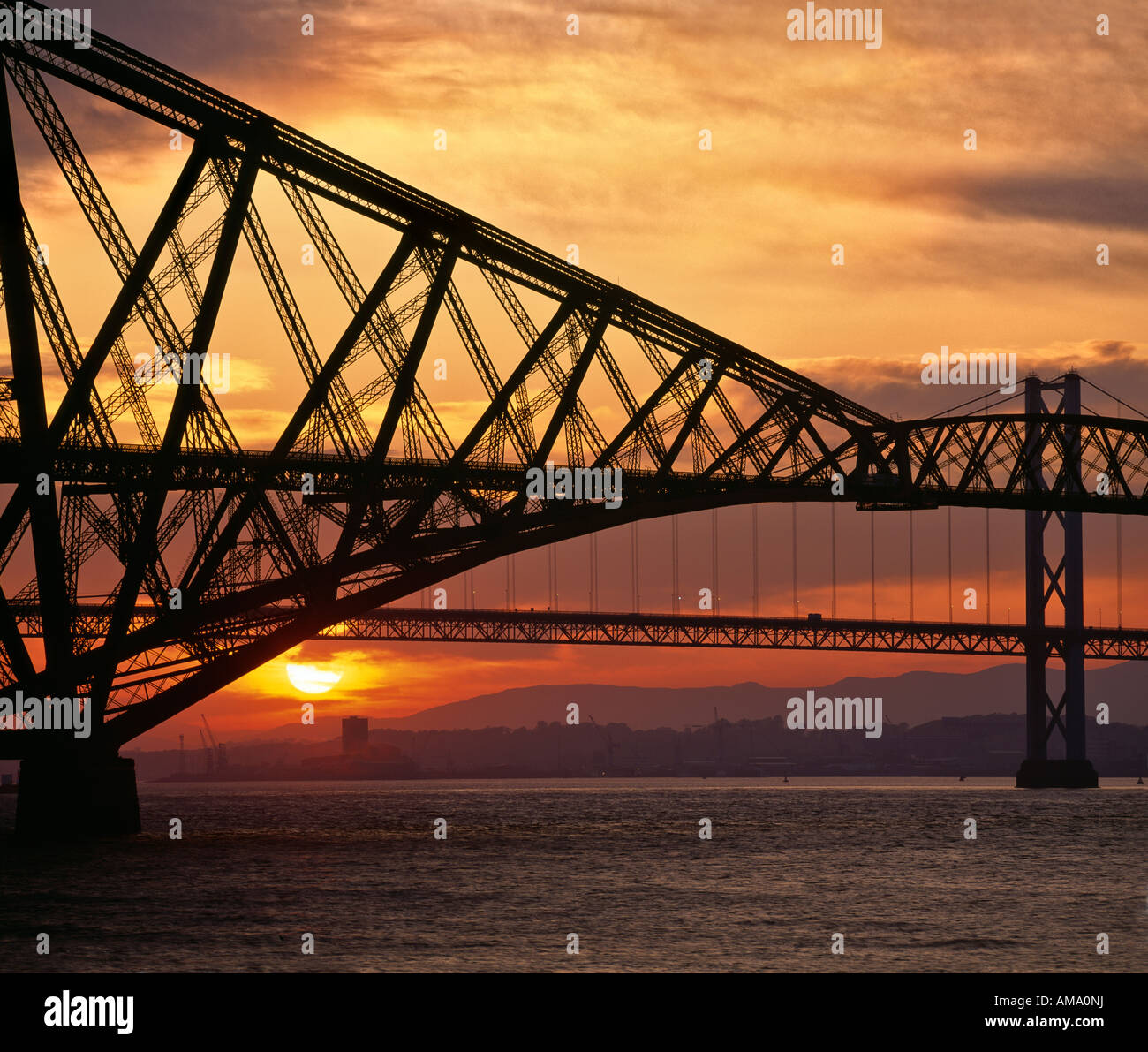 Forth Rail Bridge at sunset with road bridge beyond over Firth of Forth between Queensferry and ...