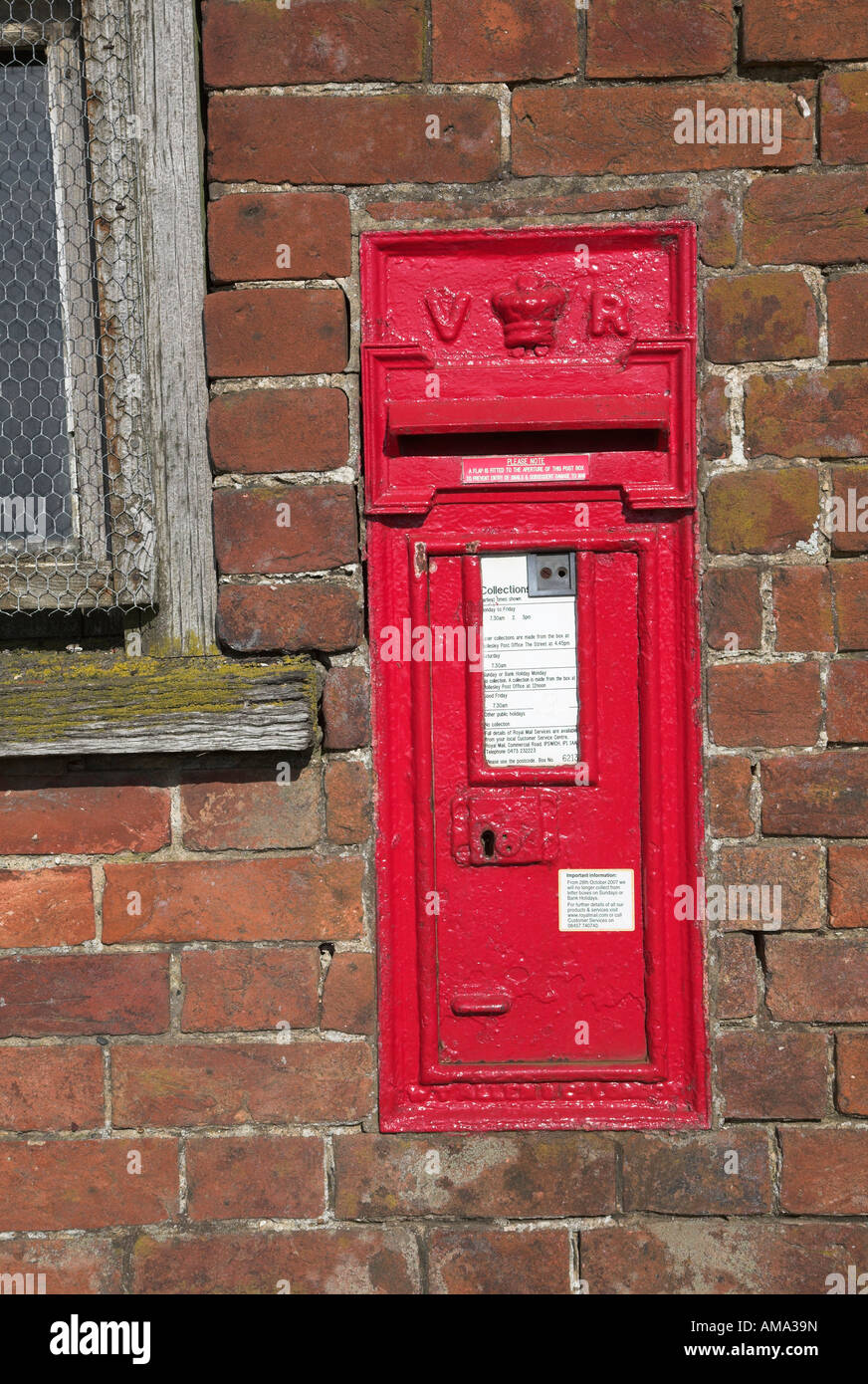 Red wall mail post box in red brick wall Stock Photo - Alamy