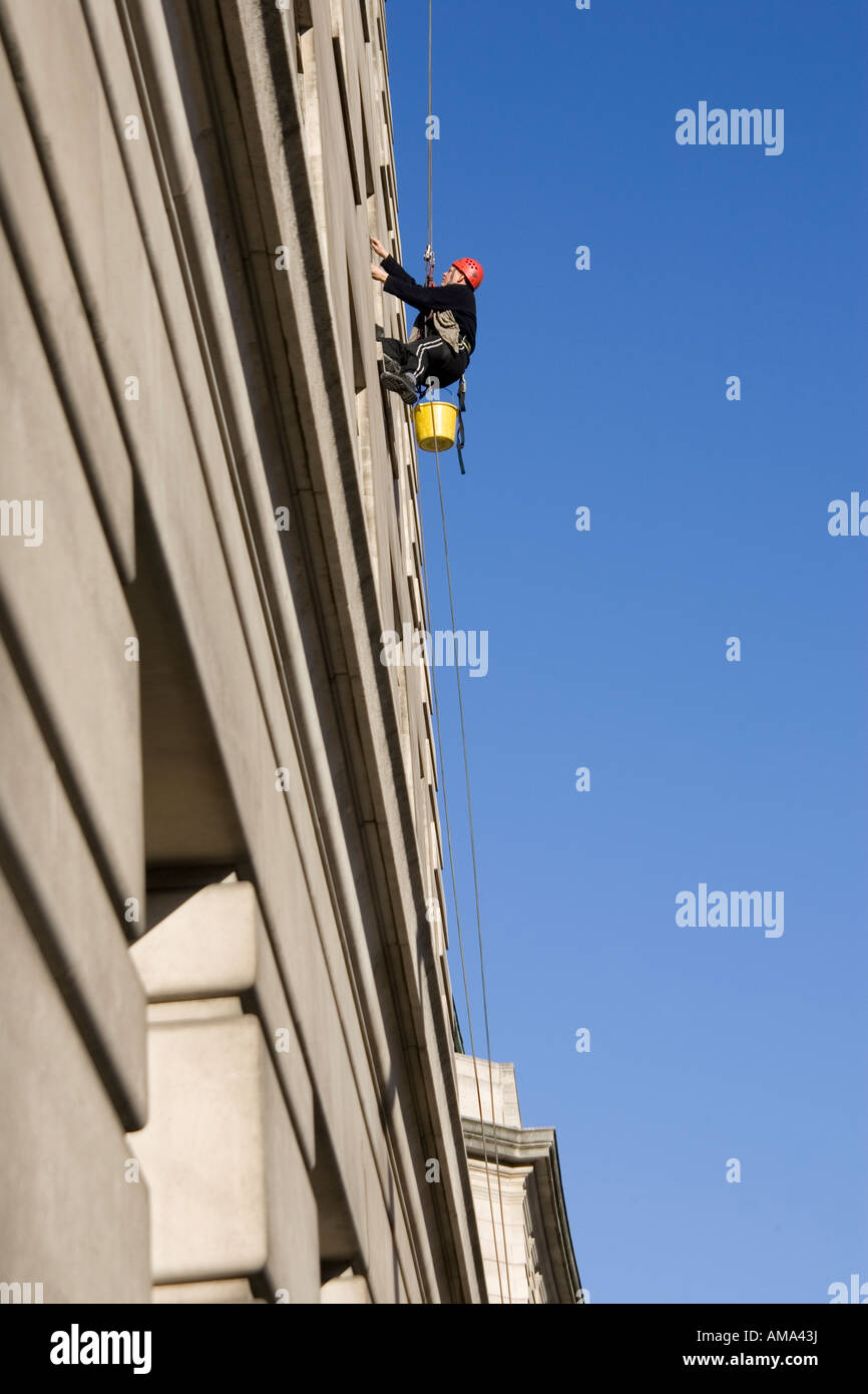 Abseiling window cleaner Stock Photo - Alamy