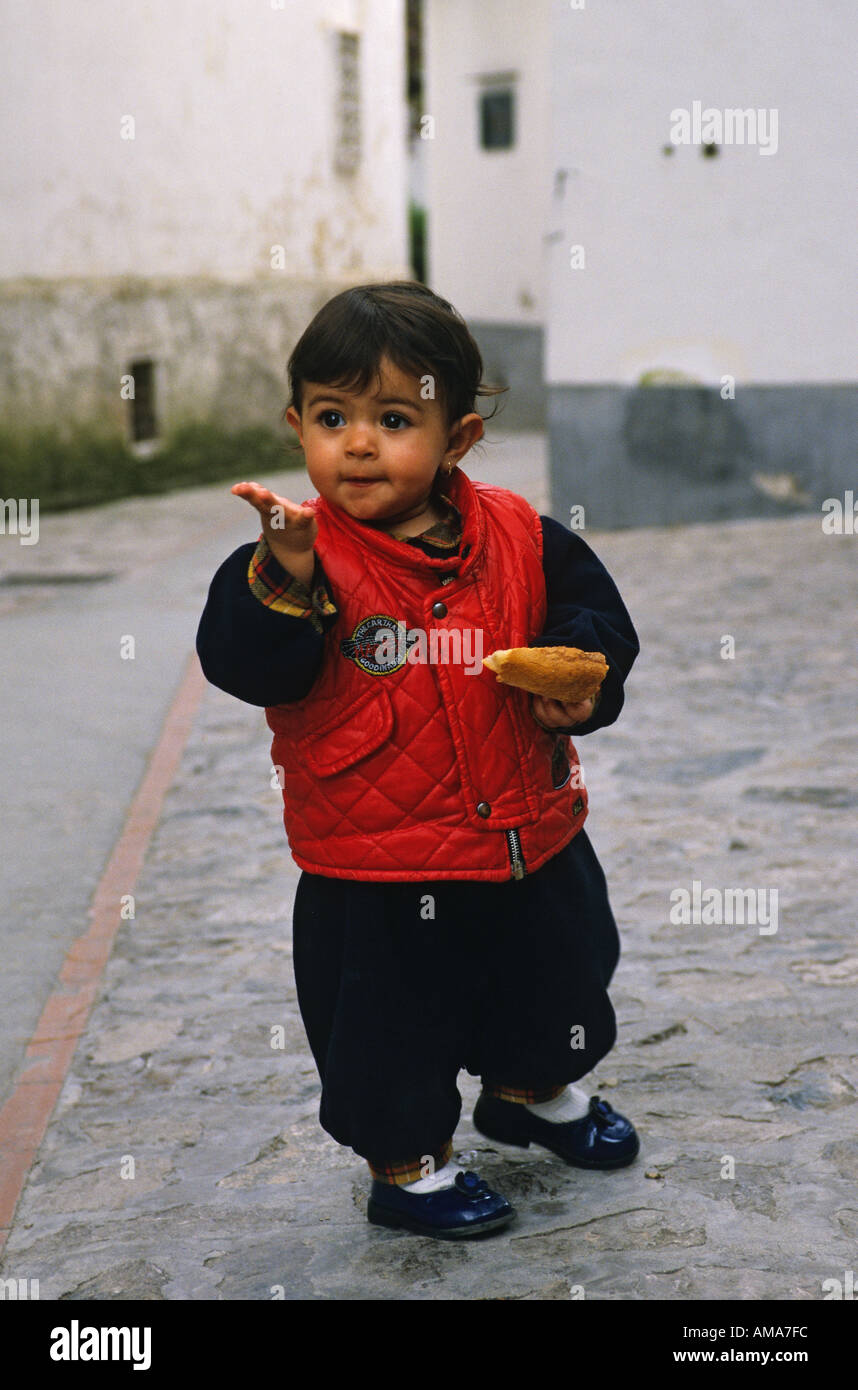 Italy Campania Island of Capri Anacapri child in red vest holding bread ...